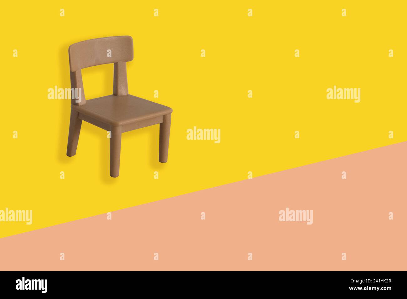 plastic model of a brown chair on a yellow background, workplace ... plastic model of a brown chair on a yellow background, workplace ...