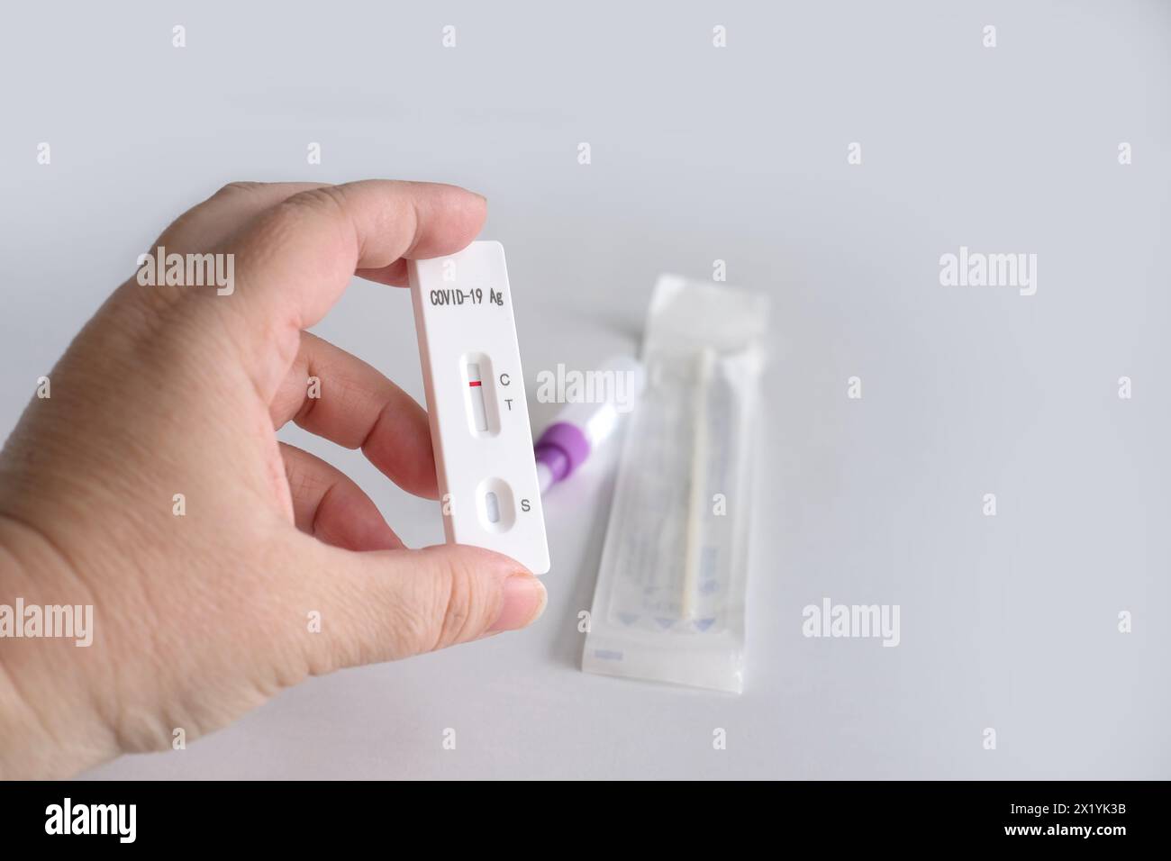 closeup female hand holding test cassette, medical disposable sterile ...