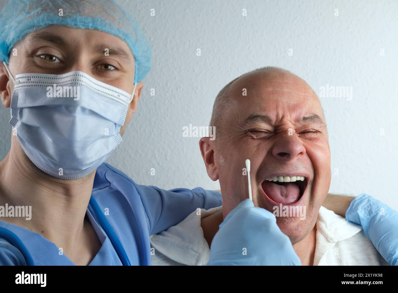 male doctor in gloves takes with swab sample from nose for analysis ...