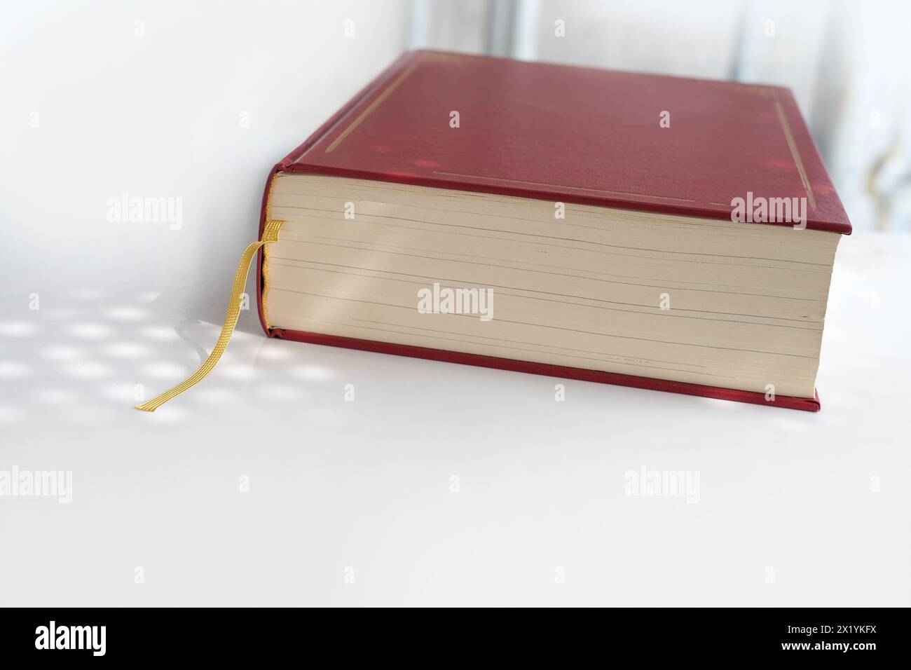 close-up of thick paper book in dark red cover, family bible, concept ...