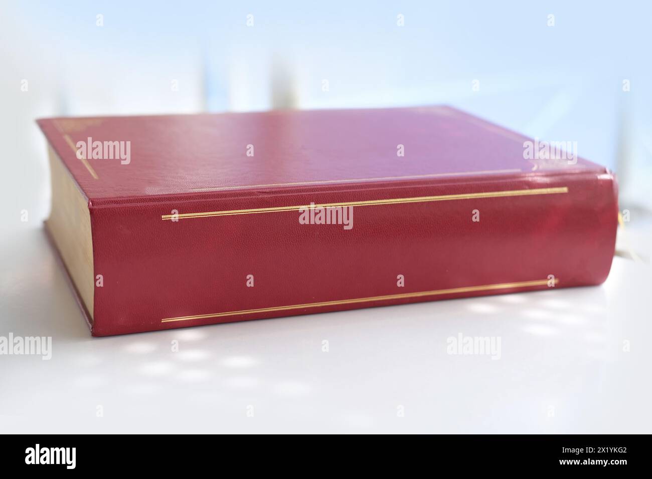 close-up of thick paper book in dark red cover, family bible, concept ...