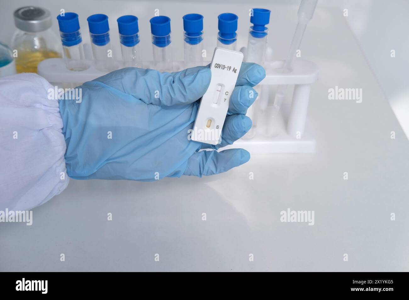 closeup male hand of a medic holds a test cassette, medical disposable ...