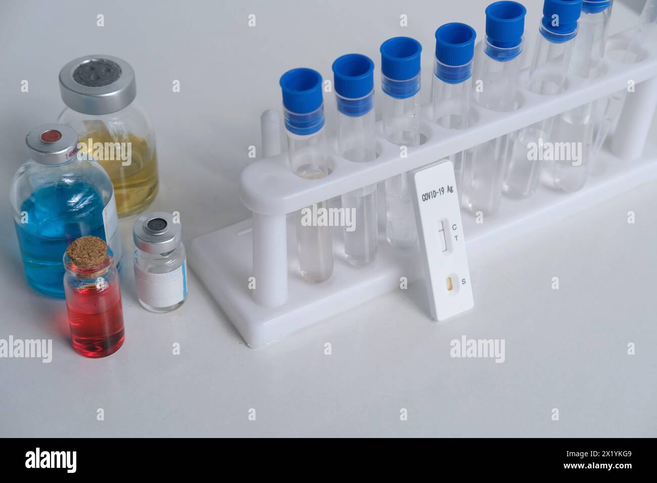 antigenic test cassette, glass test tubes with reagents, conducting a ...