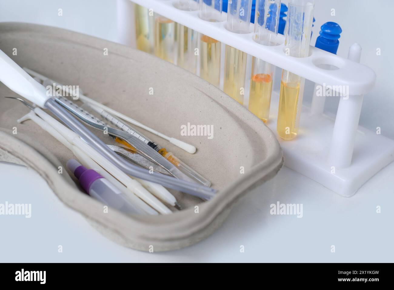 antigenic test cassette, glass test tubes with reagents, conducting a ...