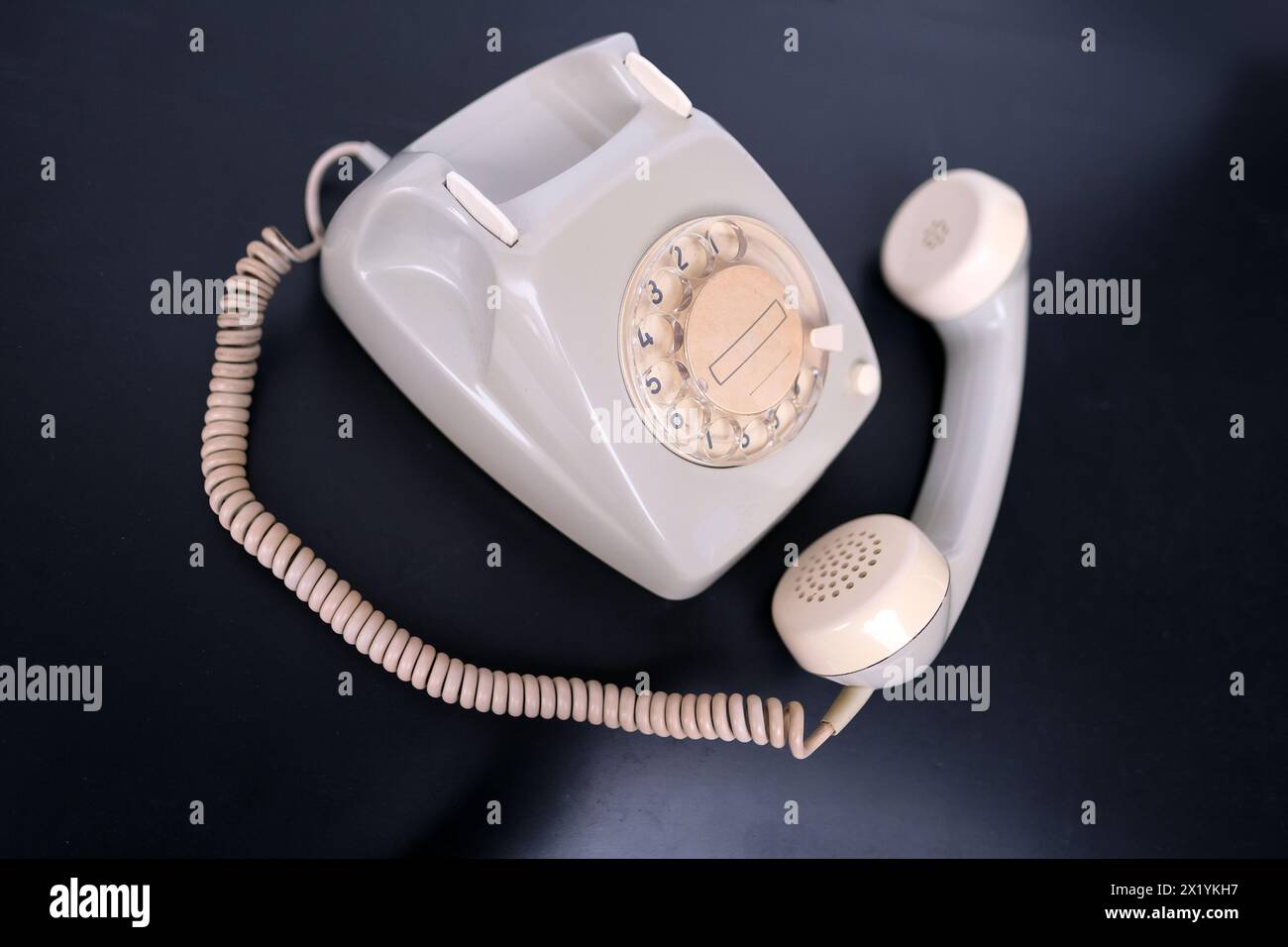 vintage white telephone set with retro style dialing dial on black ...