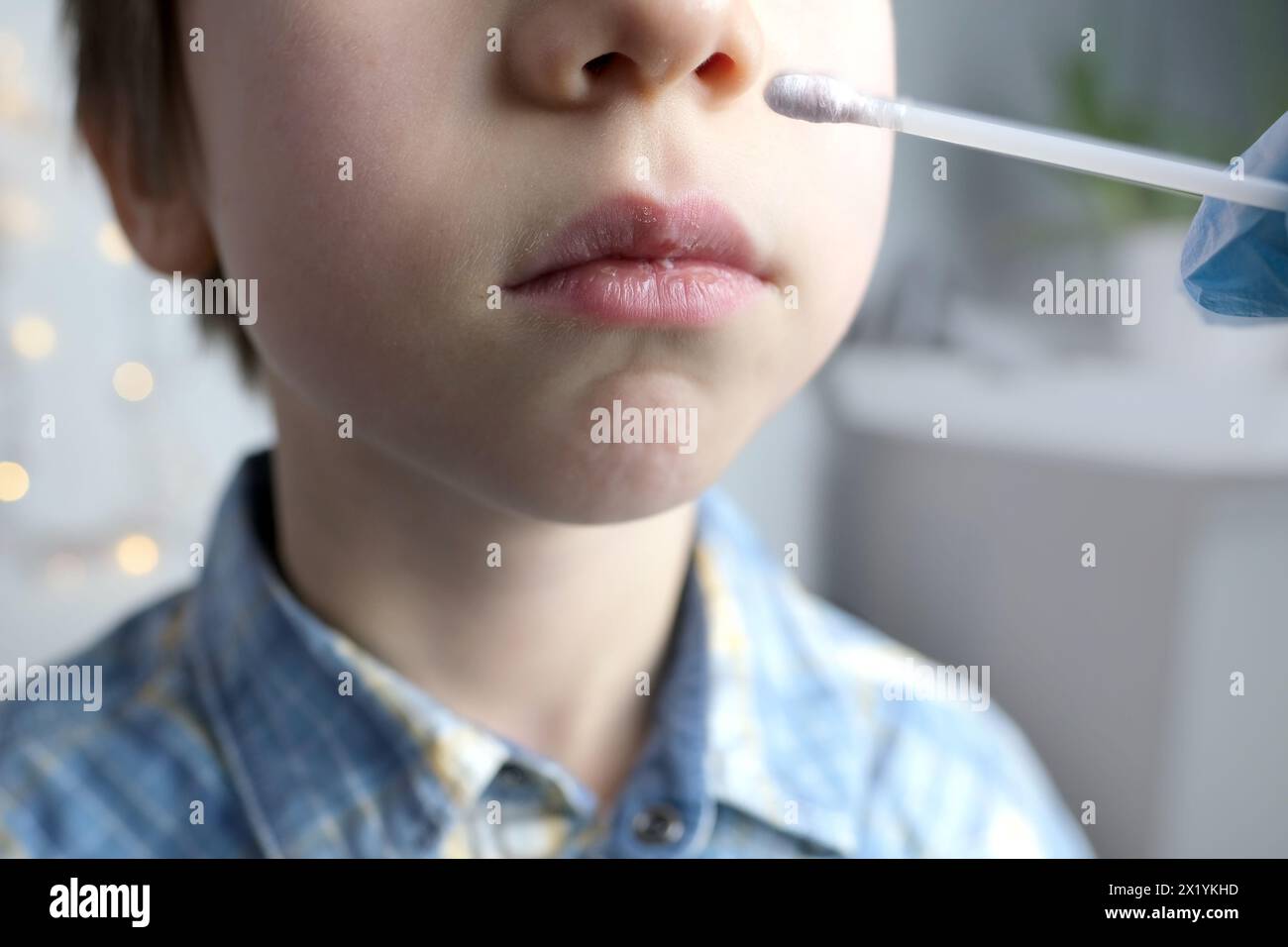 doctor takes cotton bud from child’s nose to analyze saliva, mucous ...