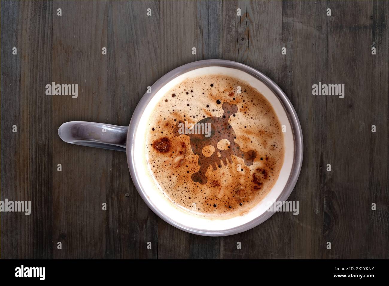 Cappuccino coffee in gray cup and saucer on an old wooden table, skull ...