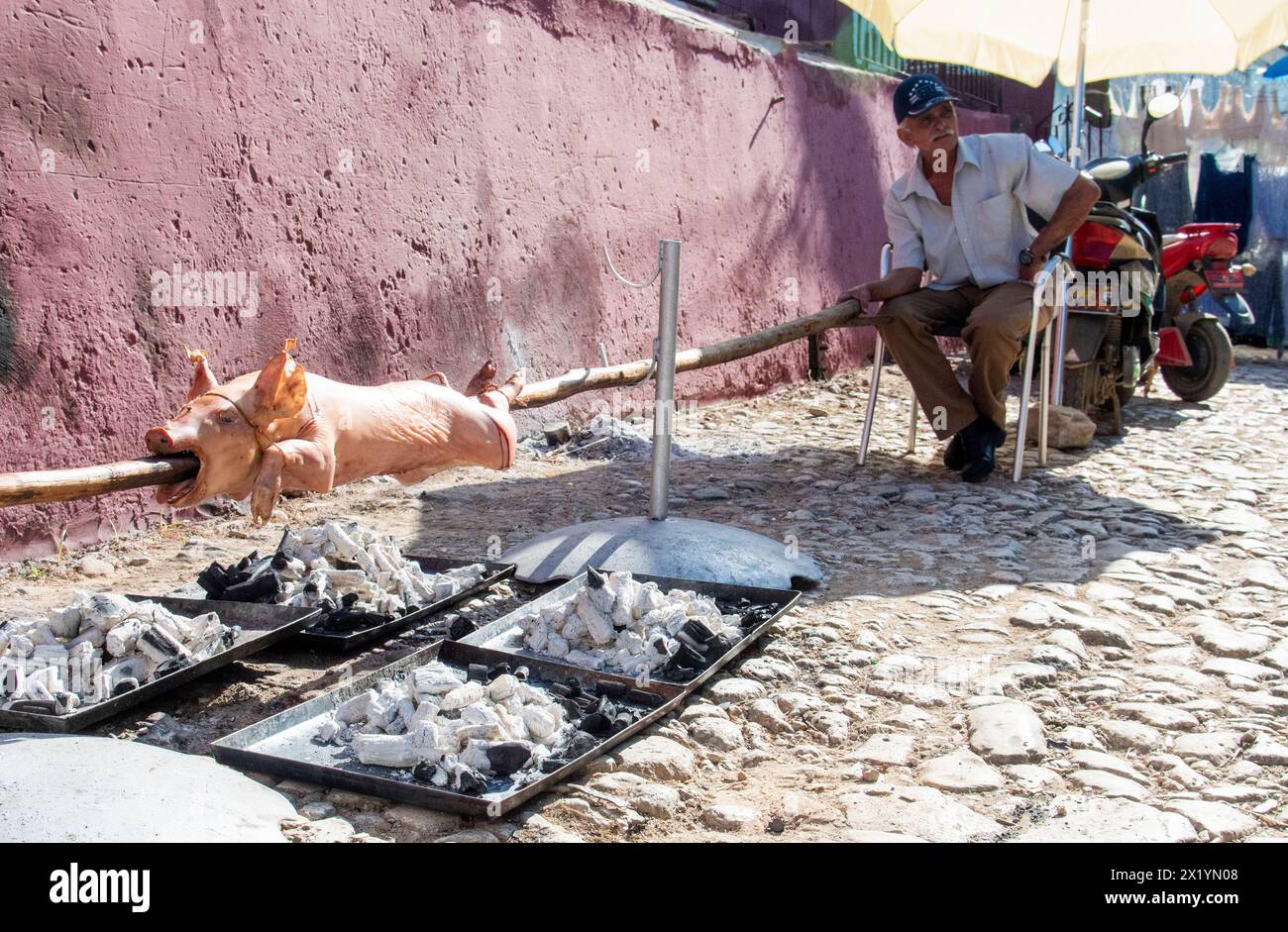 A large pig roasting on a barbeque spit in Trinidad, Cuba Stock Photo ...