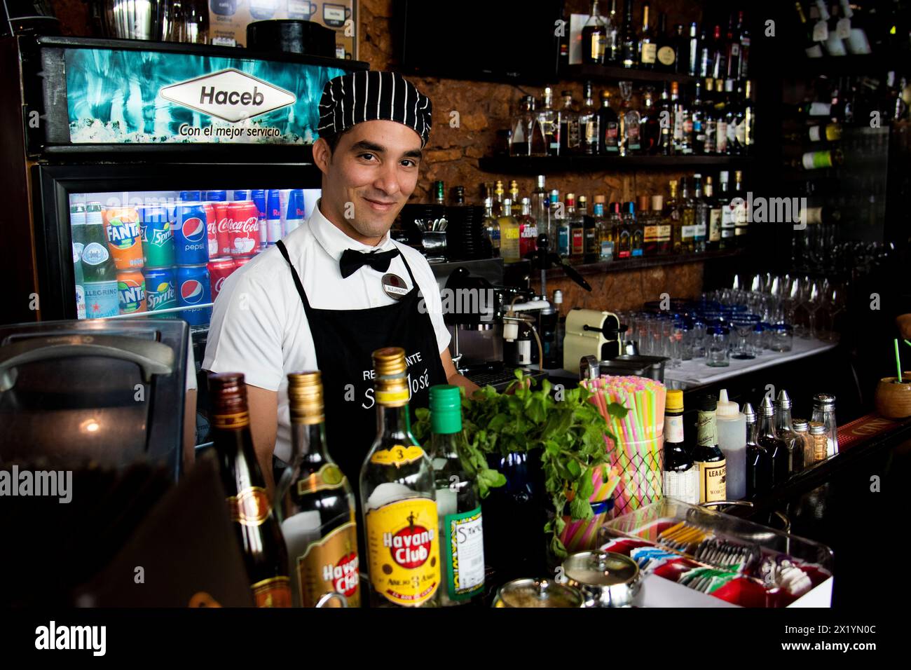 Handsome Cuban waiter and bartender works at a restaurant in Trinidad ...