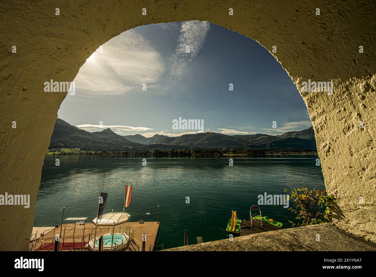 View through an arch of a bathing area on Lake Wolfgangsee and the ...