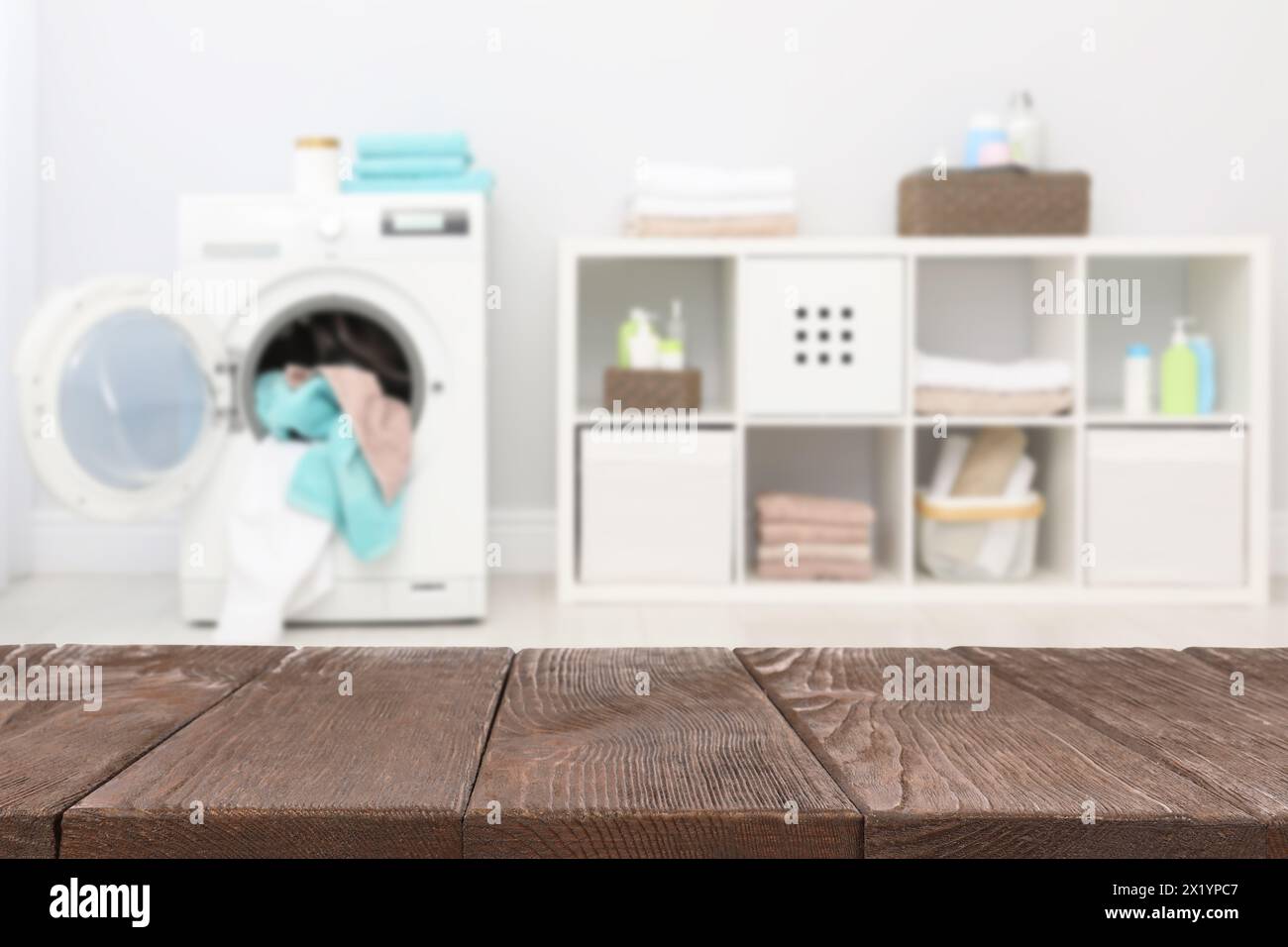 Empty wooden table in laundry room. Space for design Stock Photo - Alamy