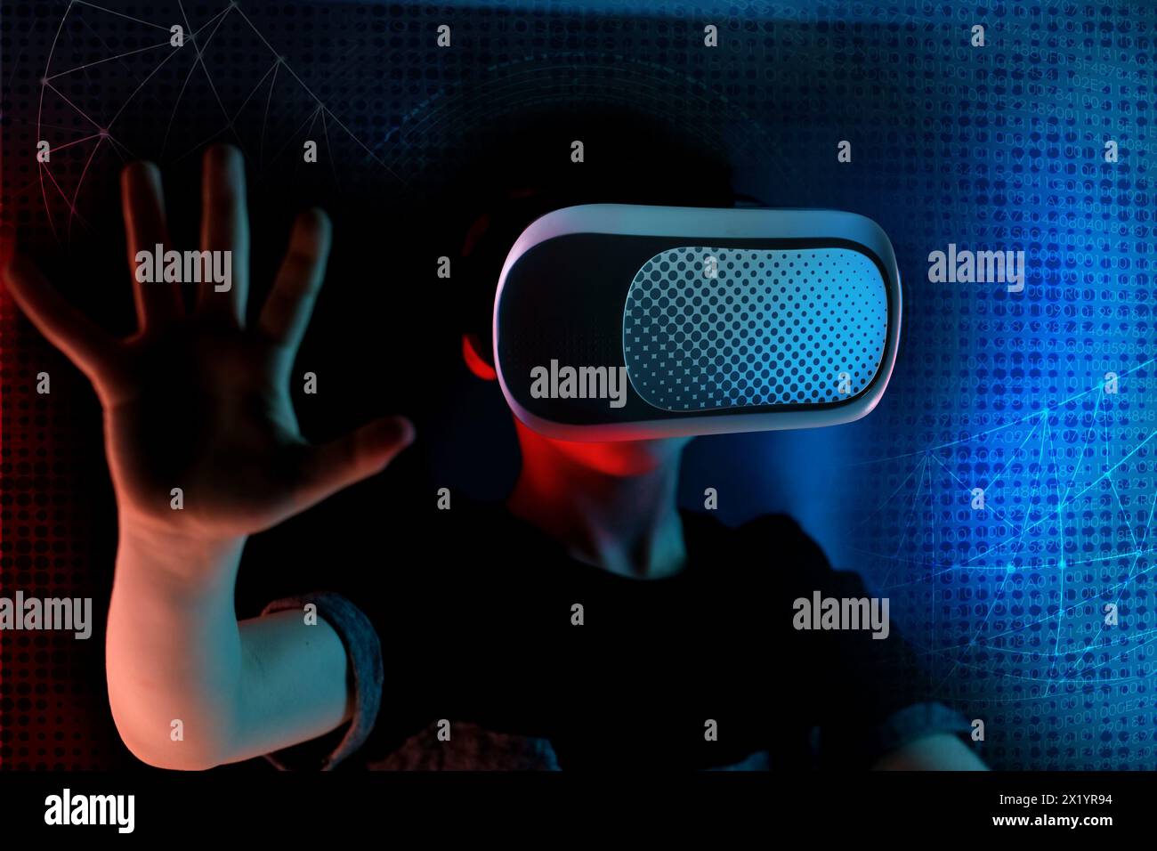 boy, child in dark room with neon lights in modern VR glasses ...