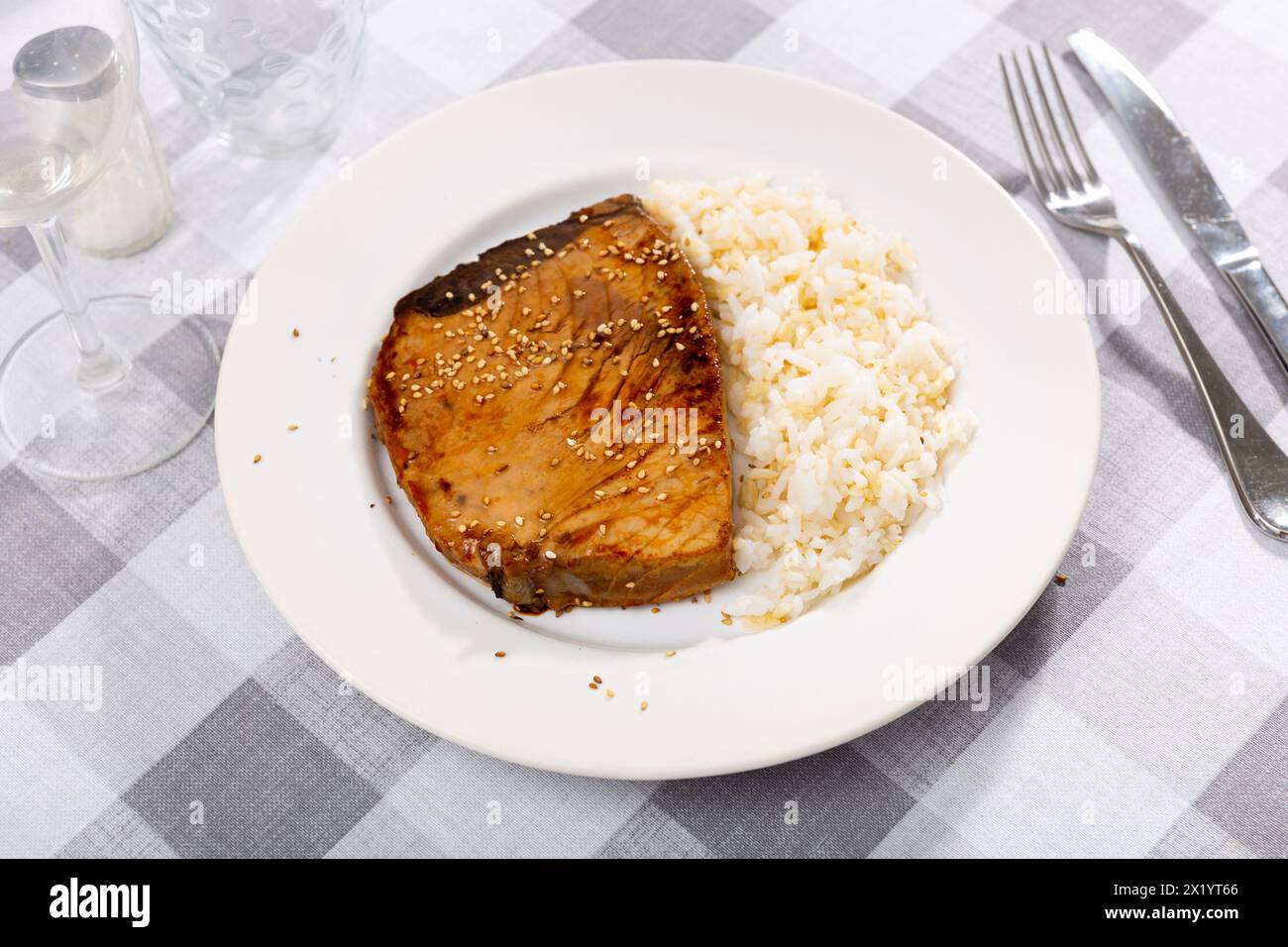 Seared tuna steak with unagi sauce and sesame served with rice Stock ...
