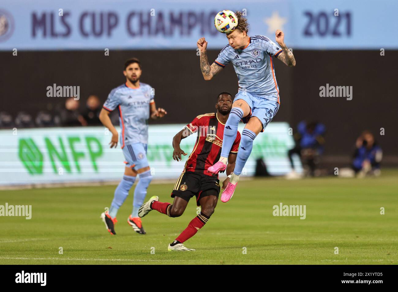 New York City FC defender Birk Risa #5 leaps up to deflect the ball ...