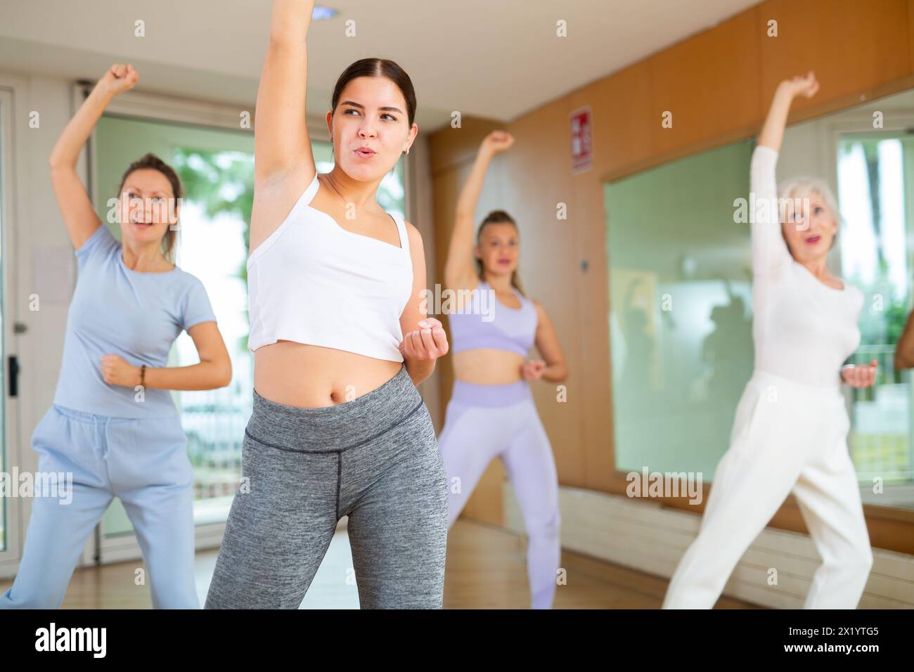 Group are practising arch movement in step jazz dance in fitness gym ...