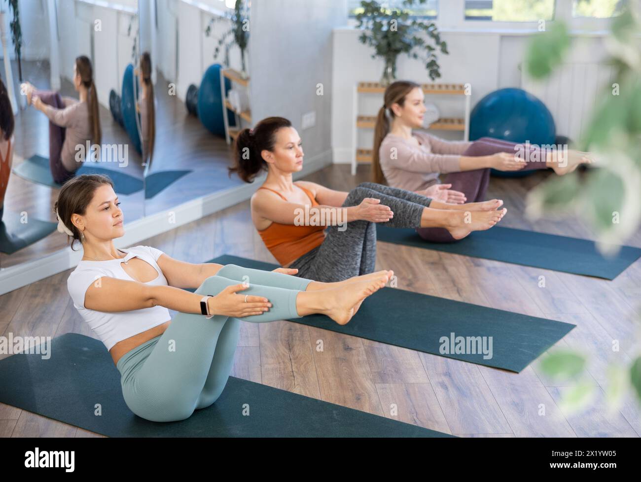 Girl teacher conducts lesson, training for girls in yoga studio and ...