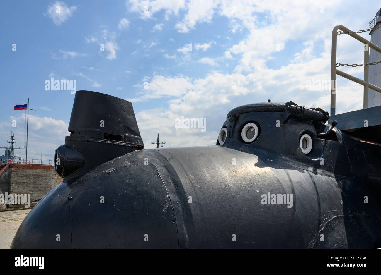 A fragment of a small submarine with a wheelhouse, portholes and a ...