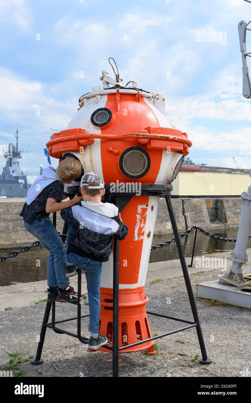 Two boys climb rigid underwater observation camera with illuminators ...