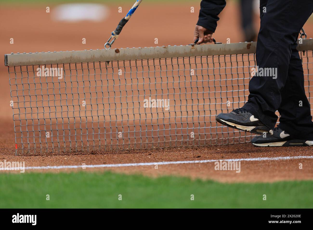 The grounds crew prepares the field before the baseball game Stock ...