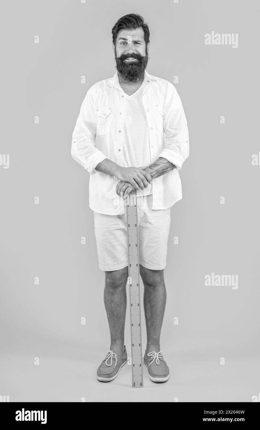 photo of happy man hold school ruler. man hold school ruler isolated on ...