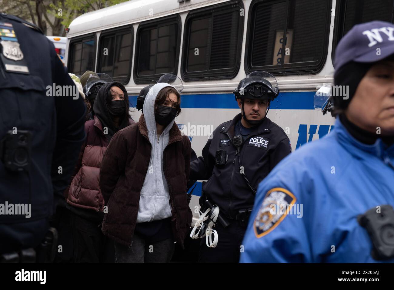 New York, United States. 18th Apr, 2024. Two students led by NYPD SRG ...