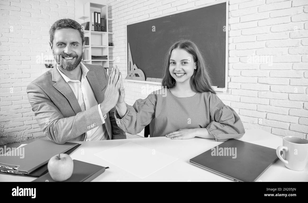 school education. happy child study in classroom with tutor. give five ...