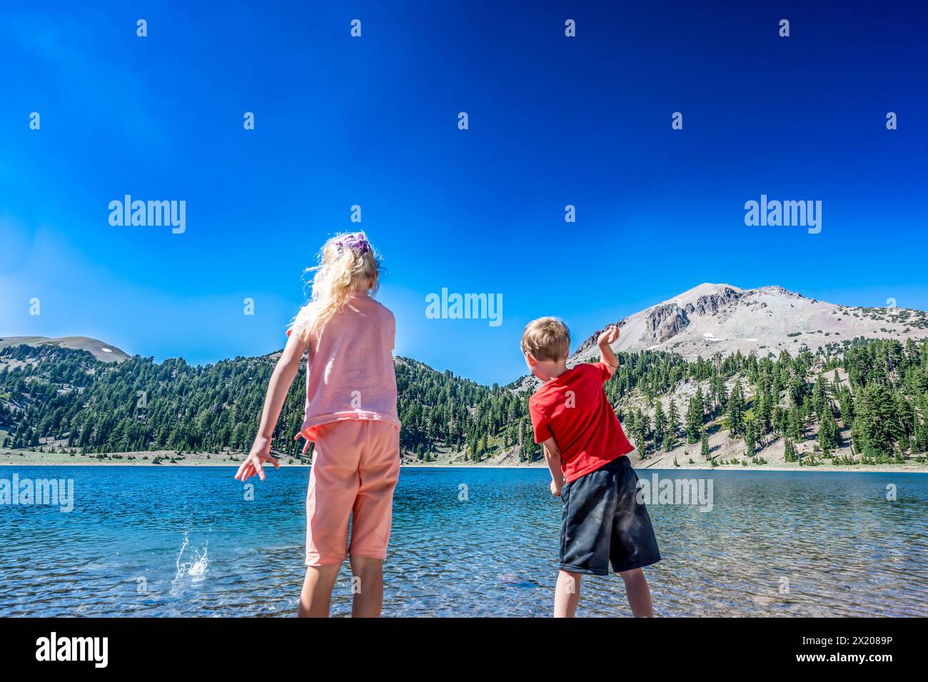 Children throwing rocks from the water's edge of Helen Lake in Lassen ...