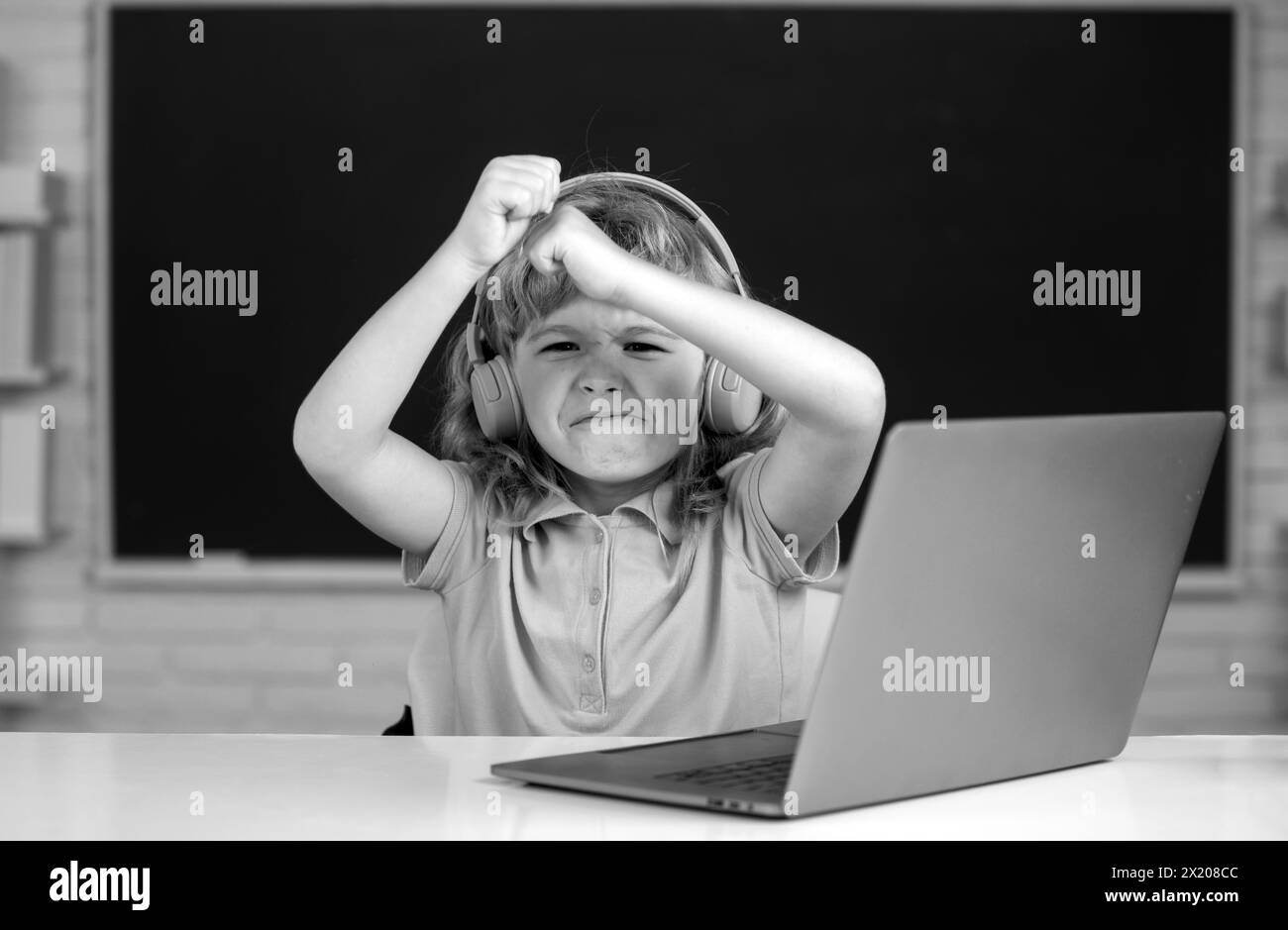Angry child using laptop computer, sad excited kid boy studying through ...