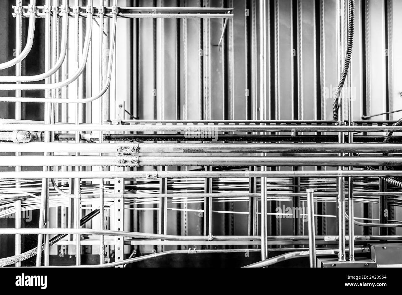 Looking up into an industrial ceiling with complex crisscross of ...