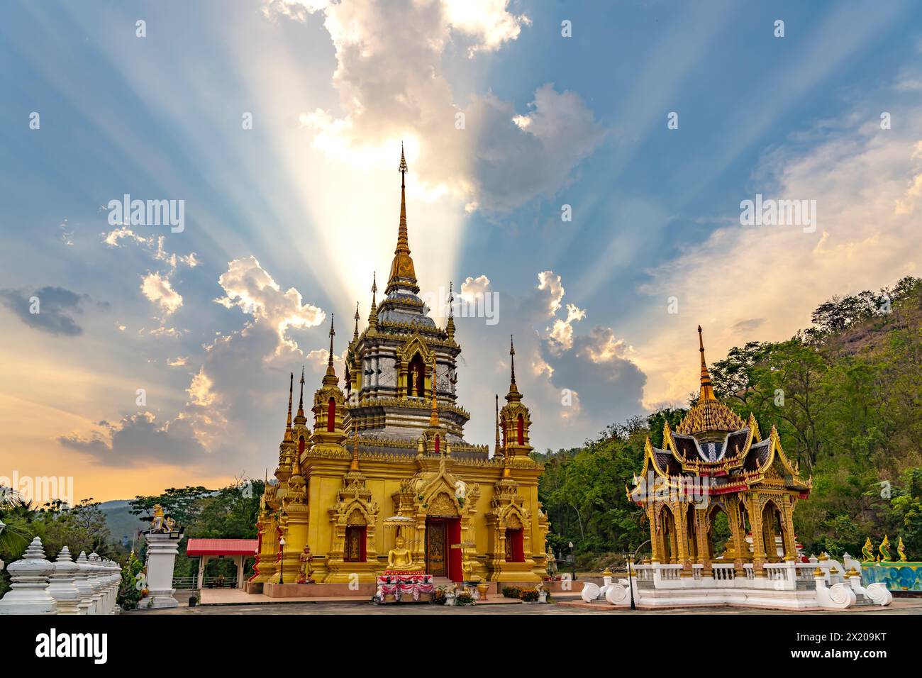 Sun rays over the Buddhist temple Wat Namtok Mae Klang in Ban Luang, Chom Thong, Chiang Mai ...