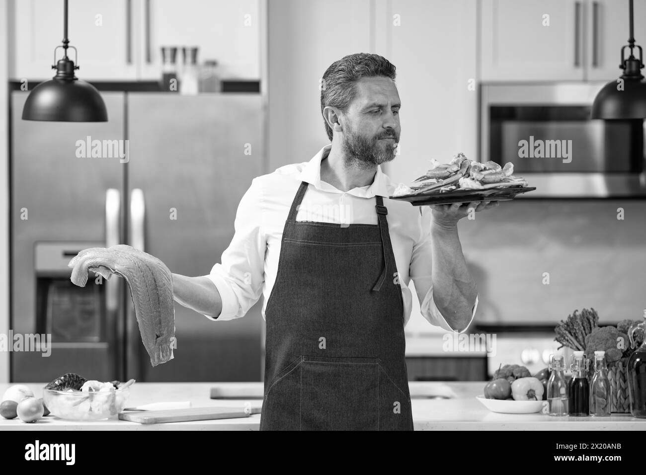 chef smell lobster and salmon seafood in the kitchen Stock Photo - Alamy