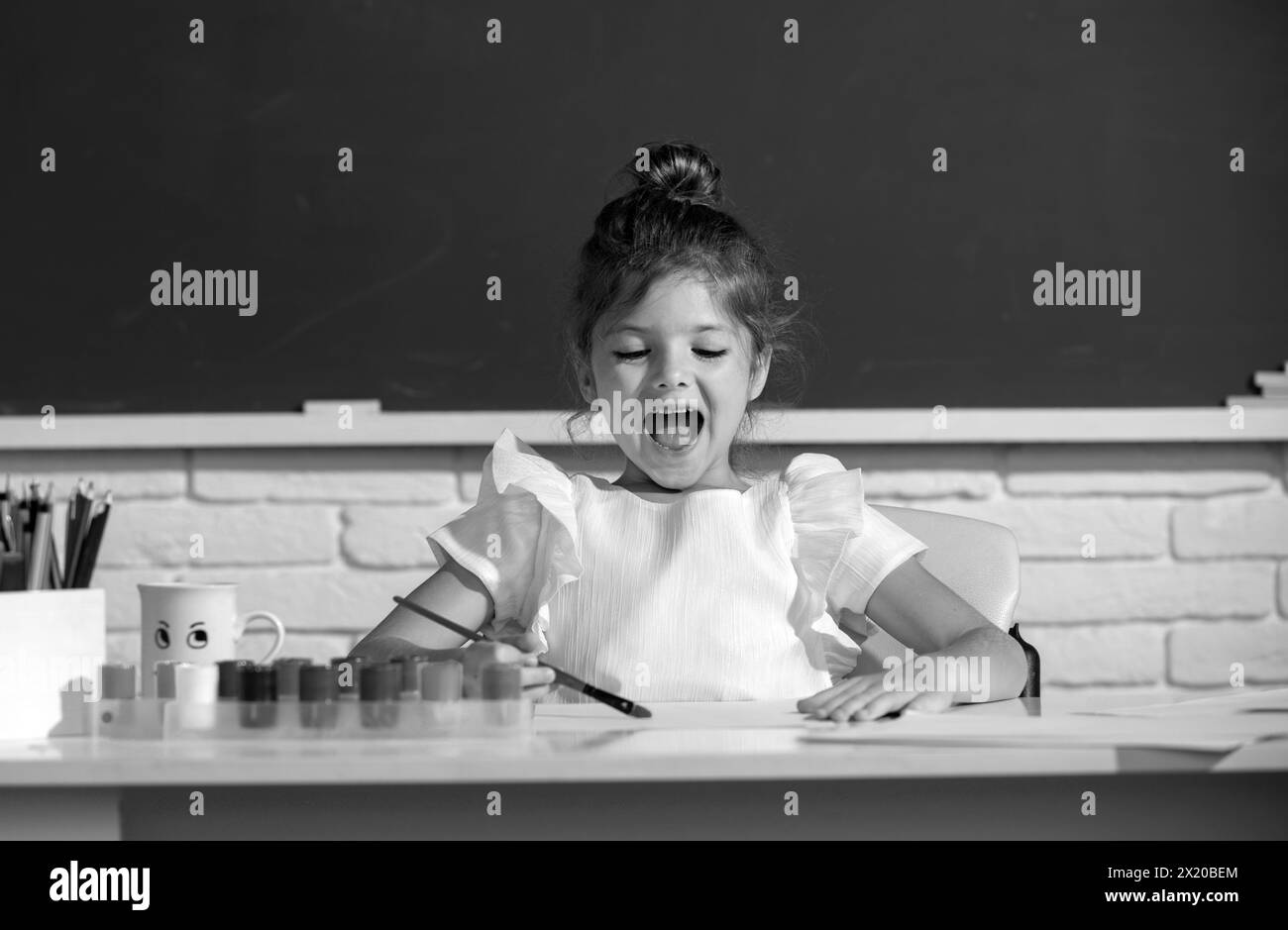 Cute little girl child painting with paints color and brush. Painting ...