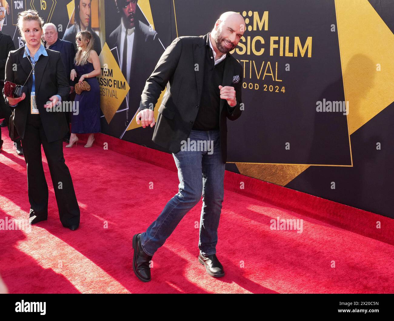 John Travolta doing the twist dance on the red carpet at the 2024 TCM ...