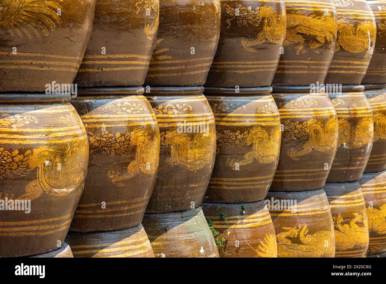 Rows of glazed water containers with a dragon pattern Stock Photo - Alamy