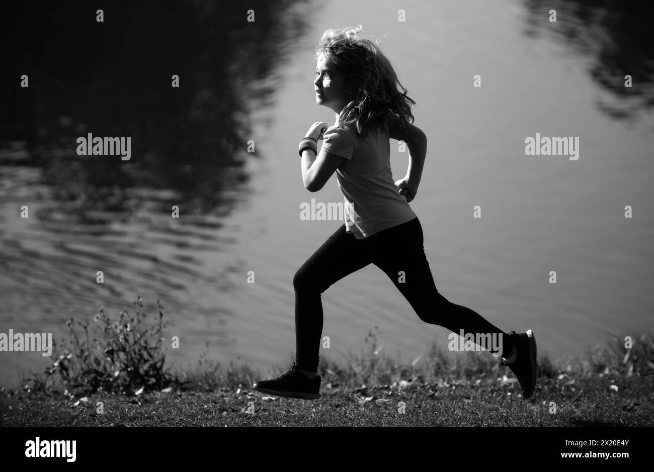 Children running near lake Black and White Stock Photos & Images - Alamy