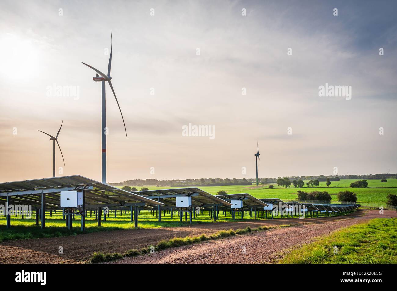 Solar park with modules, inverters and wind turbines Stock Photo - Alamy