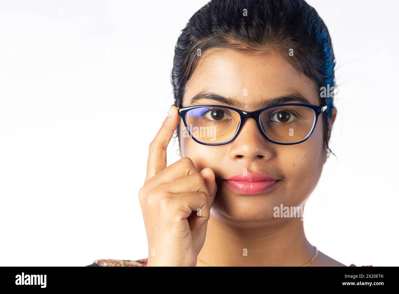 Head shot portrait of a young beautiful Indian female wearing dark ...