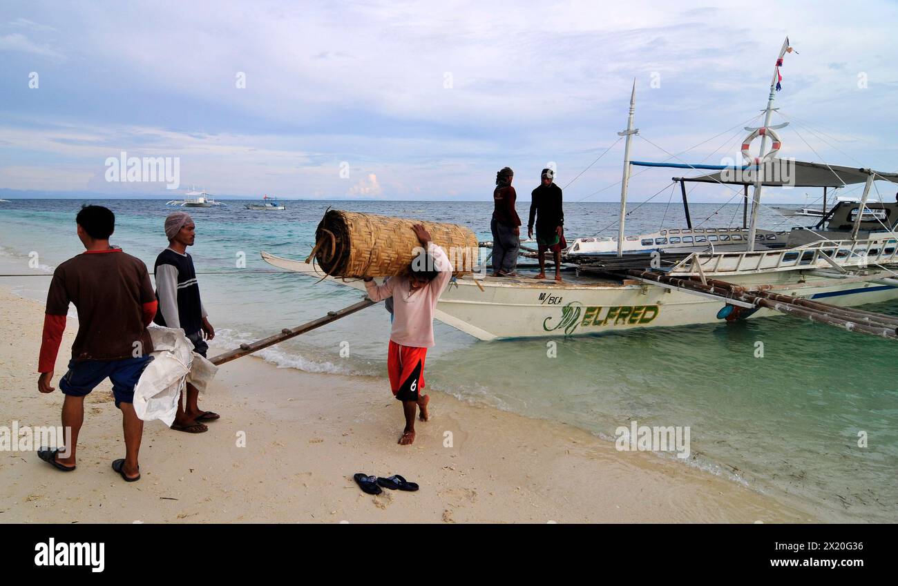 Malapascua Island, Central Visayas. Downloading equipment and ...