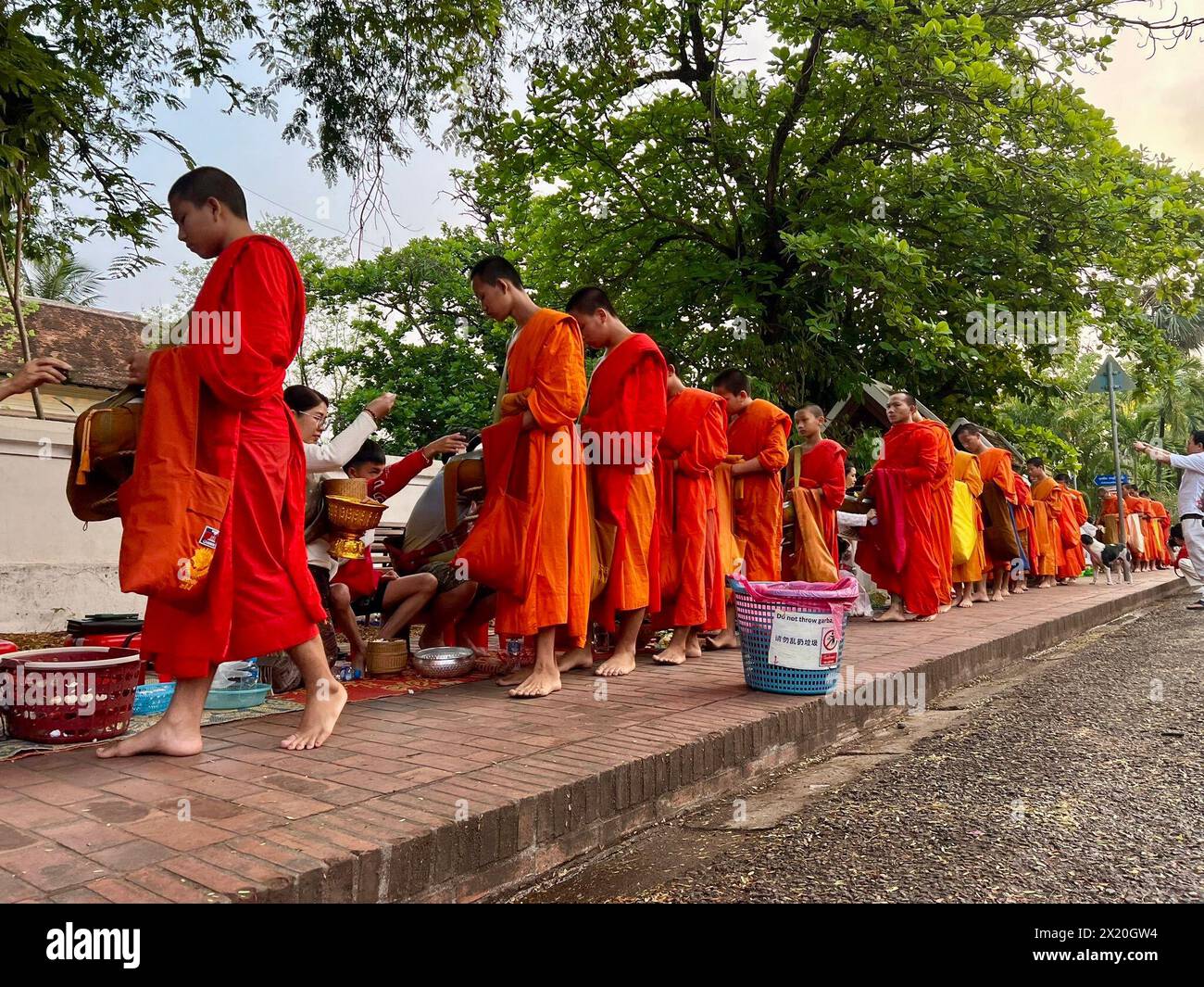 Luang Prabang, Laos. 16th Apr, 2024. Monks and novices parade through ...