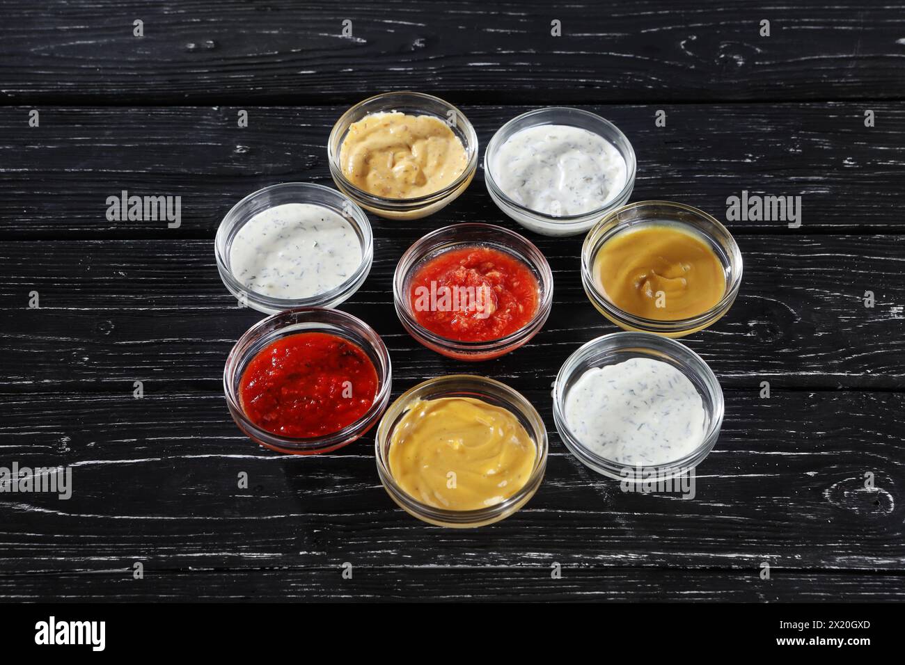 Different types of sauces in bowls on a cutting Board with garlic Stock ...