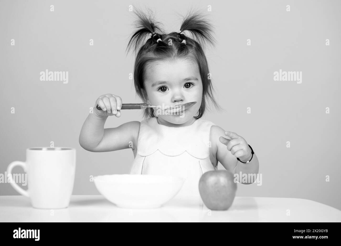 Kid eat healthy nutrition, baby food. Babies eating with spoon. Kid ...
