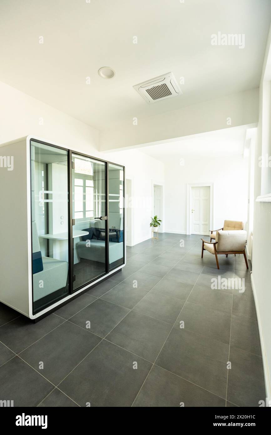 Contemporary office with large glass meeting room, minimalist furniture ...