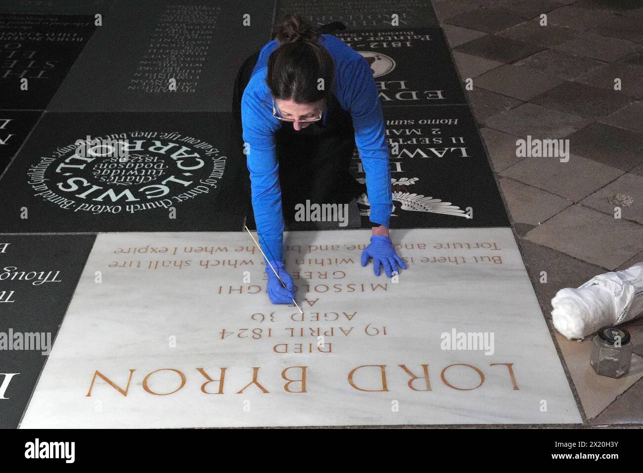Conservator Lucy Ackland cleans Lord Byron's memorial stone in Poets ...