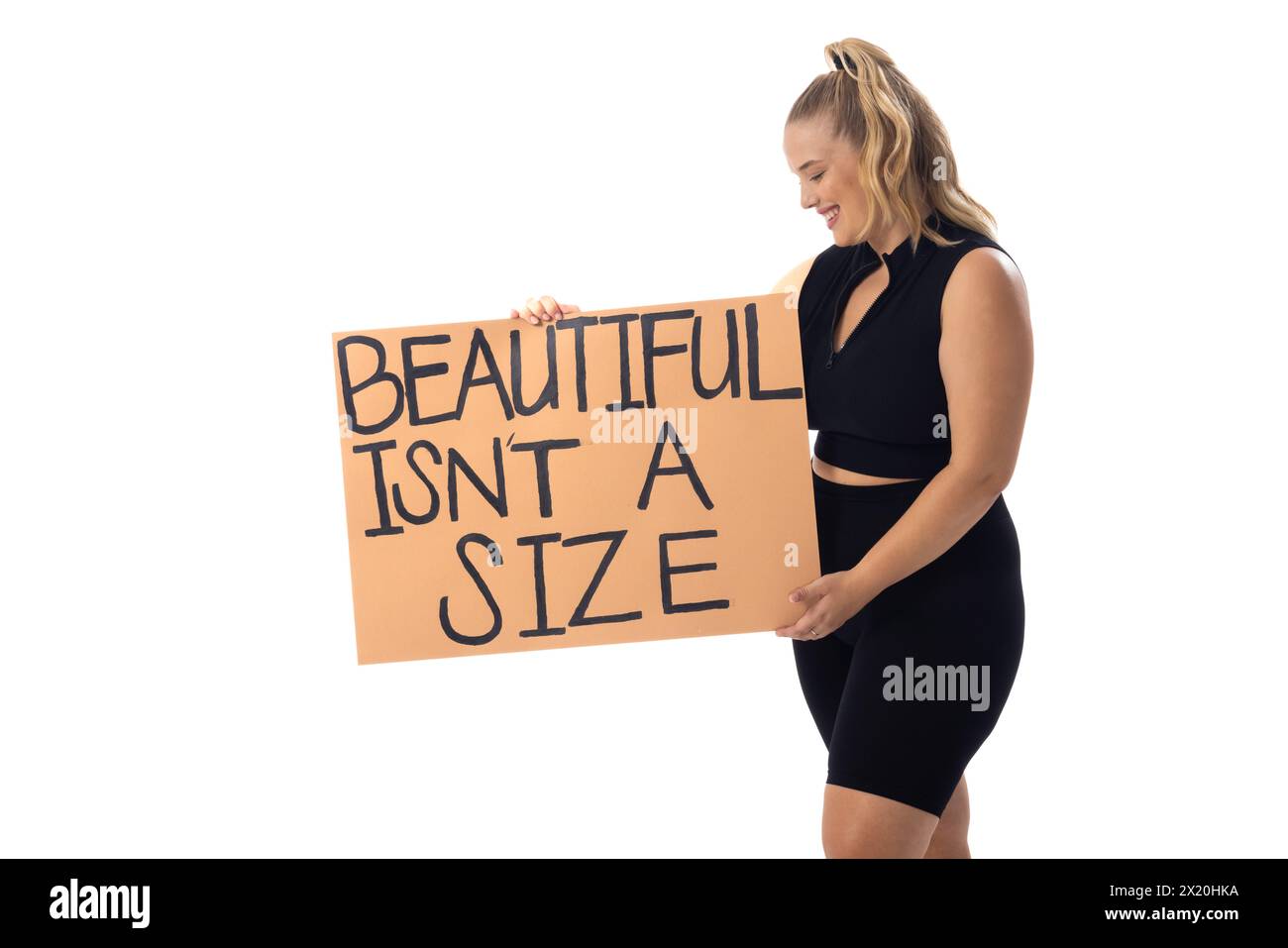 Caucasian young female plus size model holding poster, wearing black ...