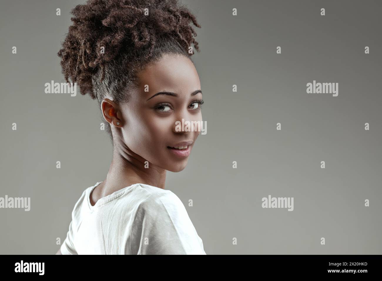 Almost facing away, she looks back with a lively, charming expression ...