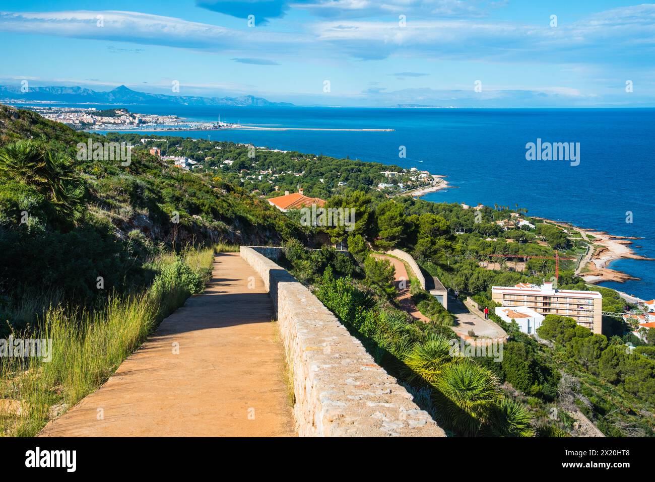 View from Roman watchtower on rocky beach path Las Rotas, Denia and Bay ...