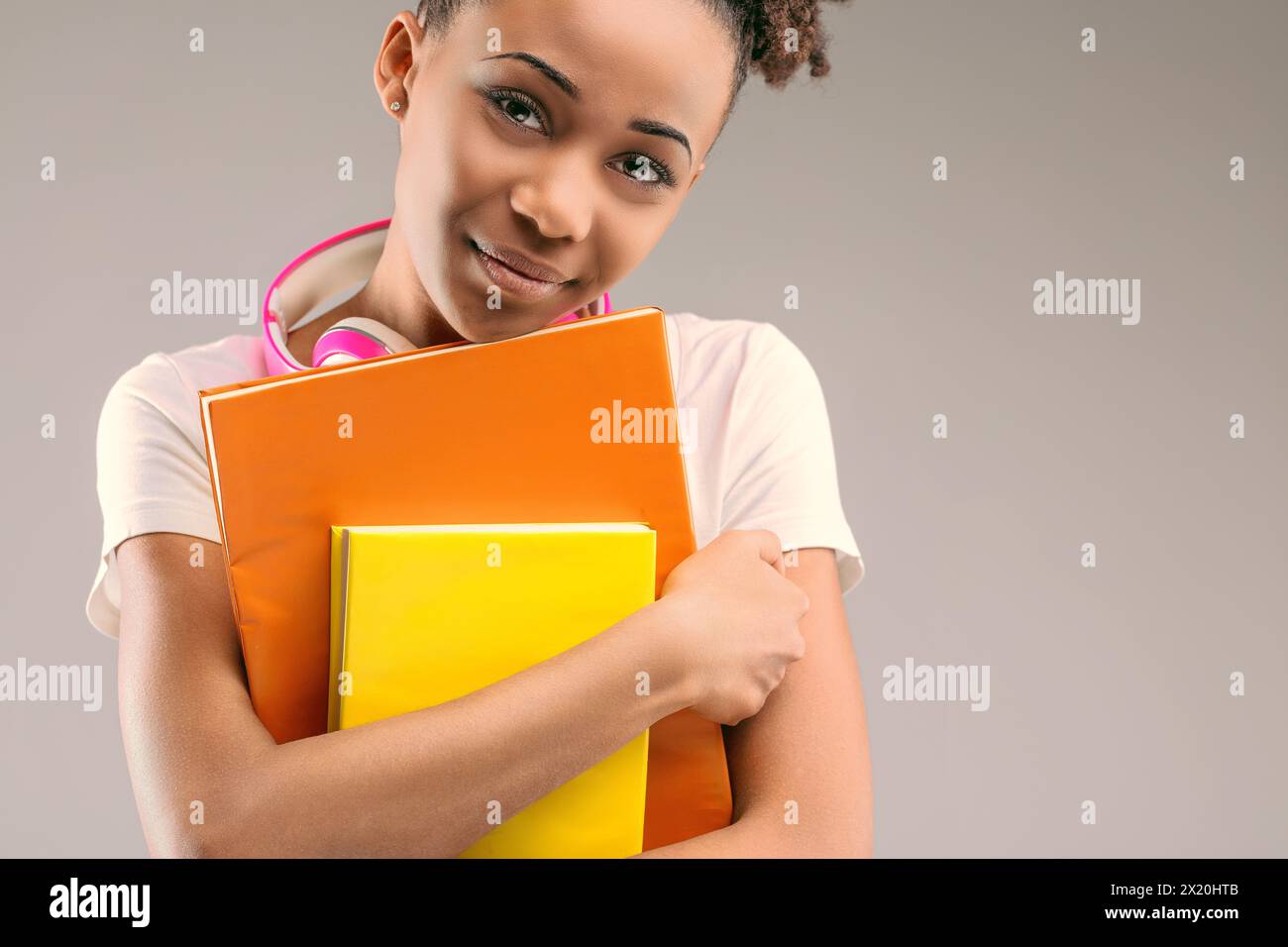 Young learner holds school supplies, exuding quiet resolve Stock Photo ...