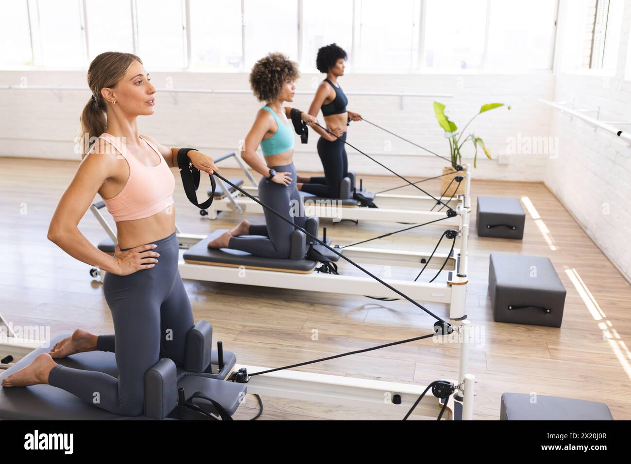 Exercising on pilates reformer machines hi-res stock photography and ...