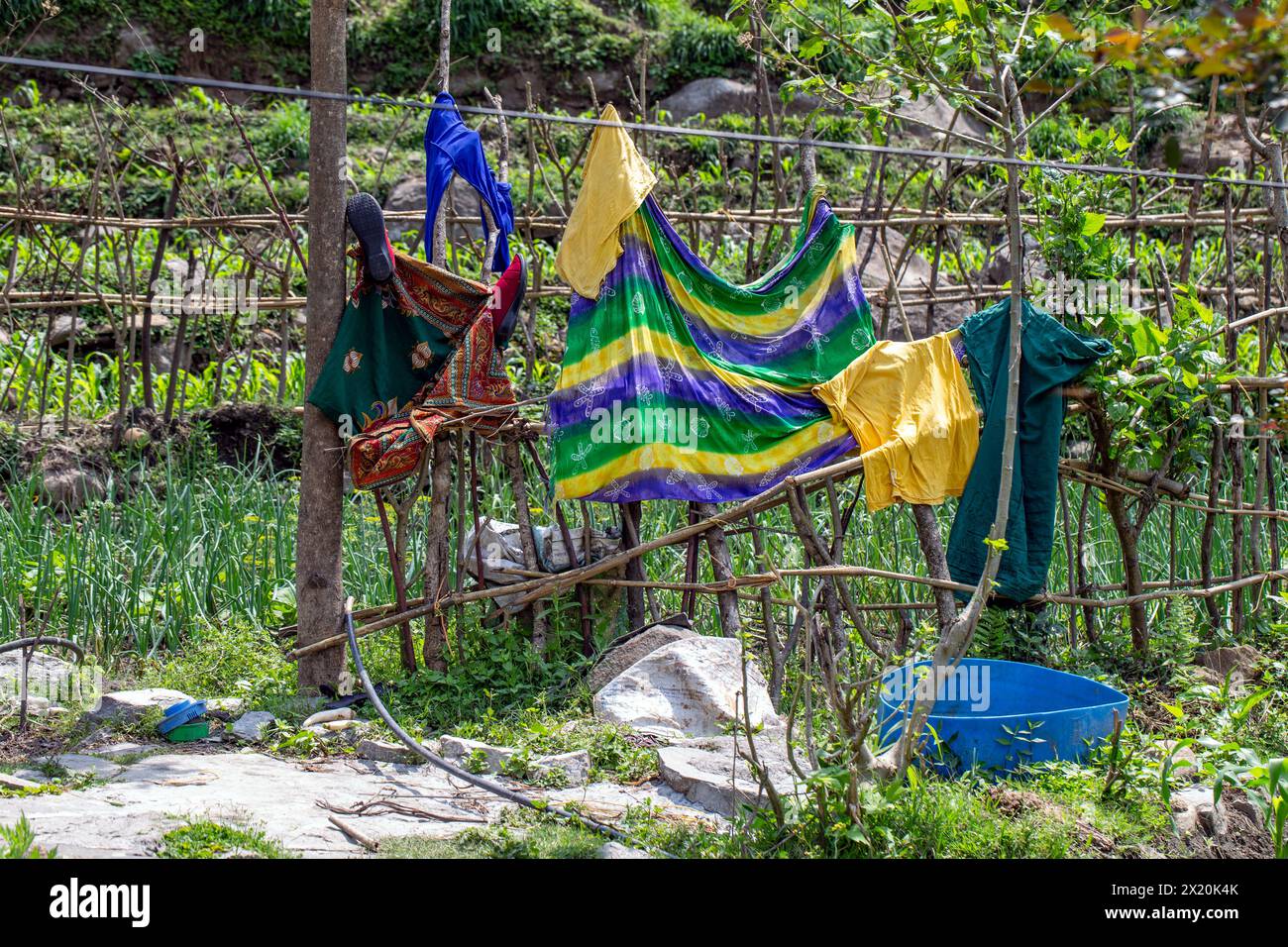 Clothes hung on a fence to dry Stock Photo - Alamy