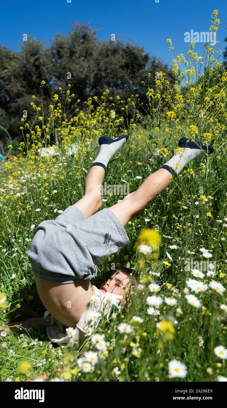 Boy child playing grass flowers hi-res stock photography and images - Alamy